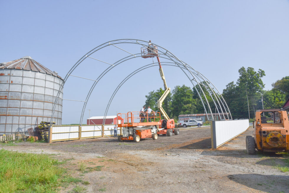 9:00: Once the first truss is upright in the proper place, a crew ...